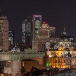 Madrid cityscape illuminated at night with landmark buildings along the skyline