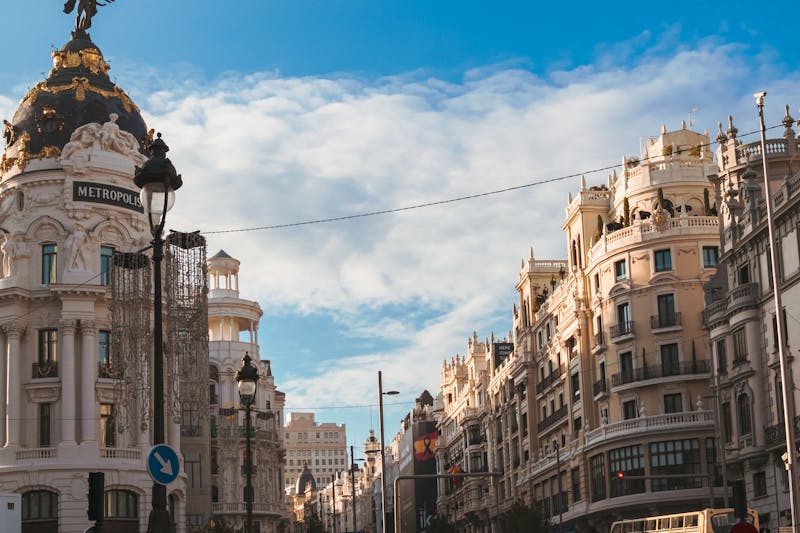 Iconic Metropolis Building on Gran Via in Madrid under a clear blue sky