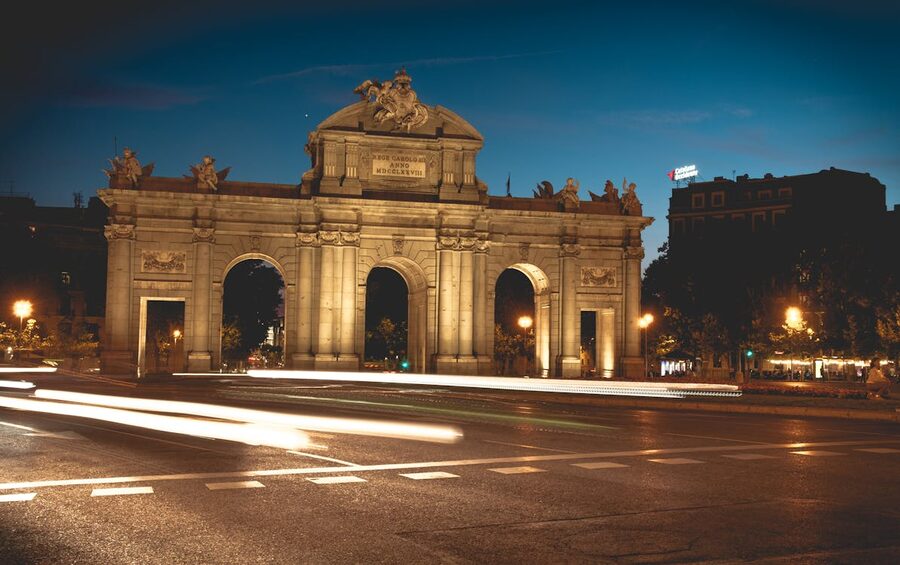 Puerta de Alcala in Madrid illuminated at night with traffic light trails