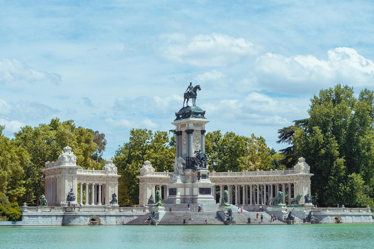 People at the boating lake by Alfonso XII monument in Retiro Park