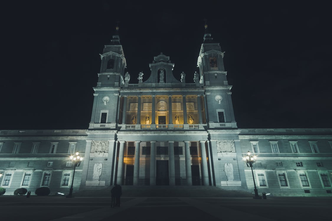 Royal Palace of Madrid lit up at night with warm golden light