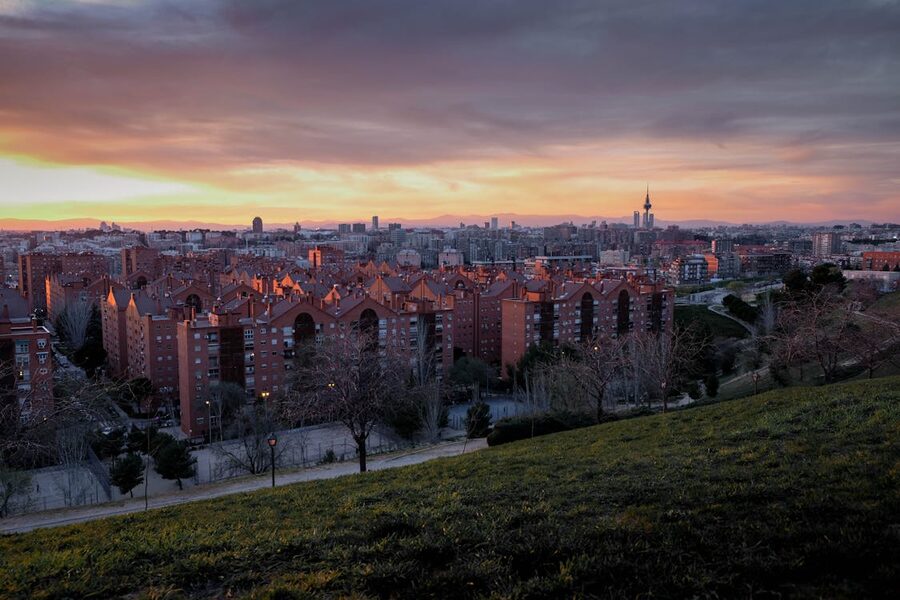 Madrid skyline at sunset viewed from a park with urban architecture