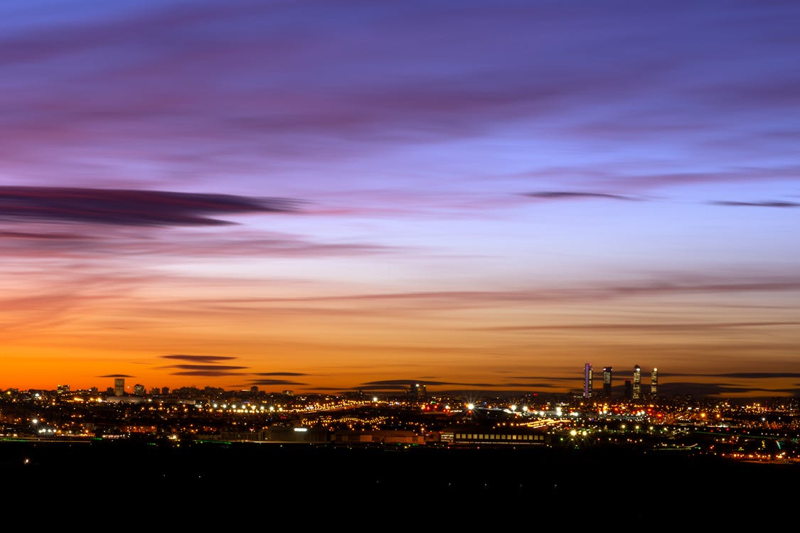 Madrid skyline at sunset with illuminated modern skyscrapers