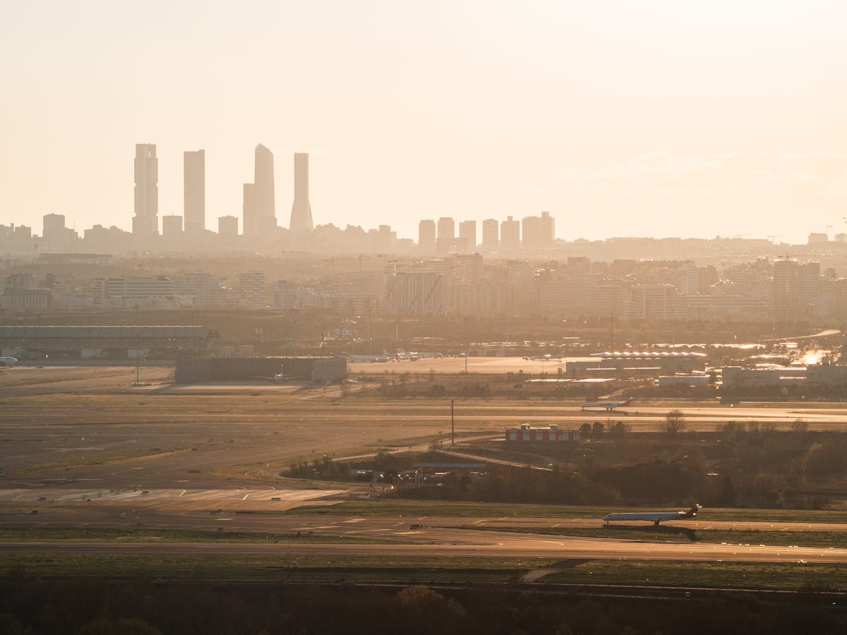 Madrid city skyline bathed in golden light during sunset with historic and modern buildings
