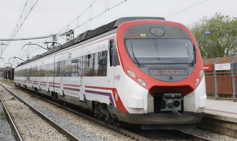Modern commuter train arriving at a station platform in Madrid Spain