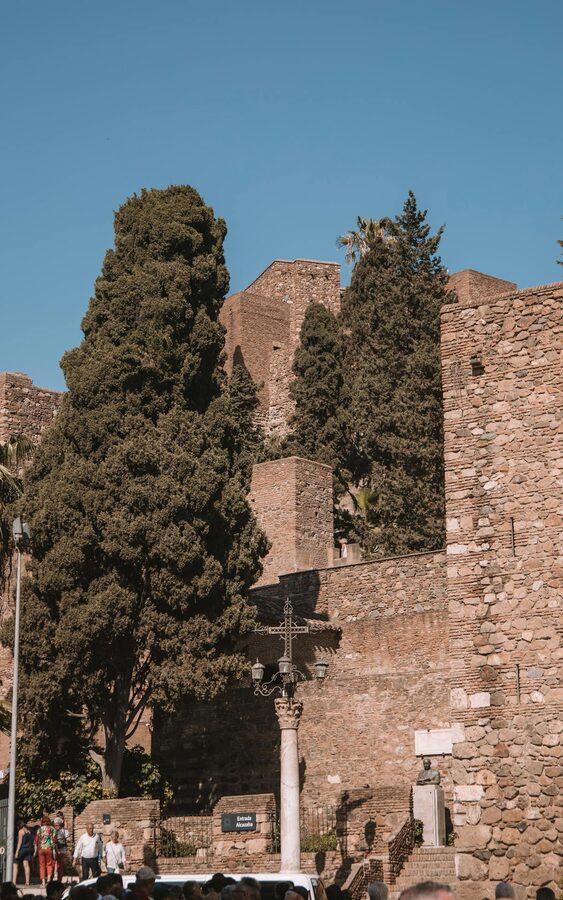 The Alcazaba fortress in M&aacute;laga under clear blue sky with surrounding greenery