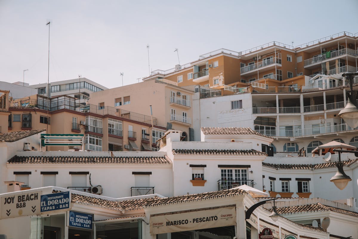 Picturesque scene of Spanish architecture in Malaga with classic balconies and restaurants