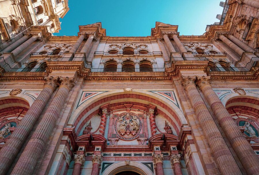 Low angle view of the ornate facade of Malaga Cathedral showing historic architecture