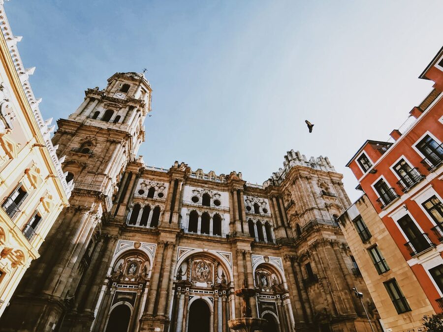 Detailed view of Malaga Cathedral ornate Baroque facade under clear sky