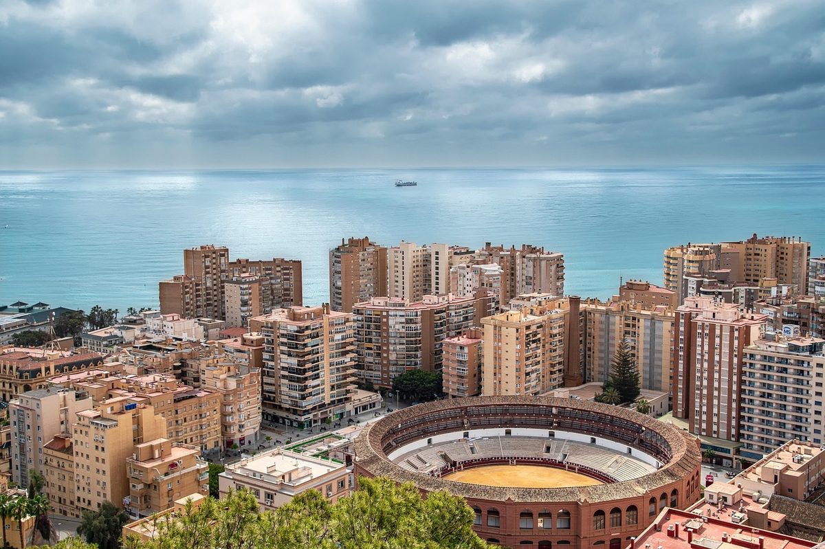 Panoramic view of Malaga city with mountains, port and buildings