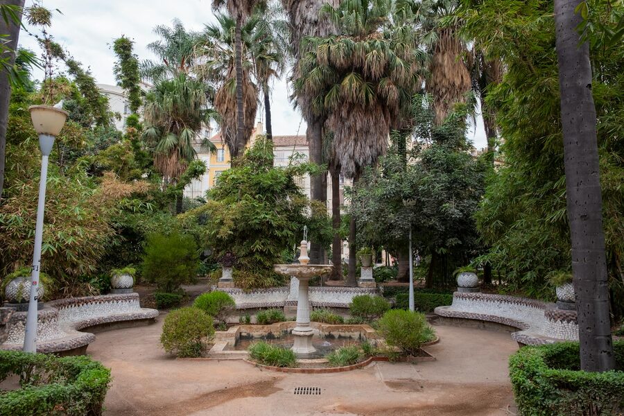 Tranquil garden with fountain surrounded by palm trees in Malaga