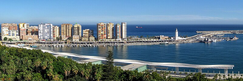 Panoramic view of Malaga harbor with boats and city skyline