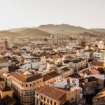 Aerial view of Malaga old town and cathedral at sunset with mountains in background