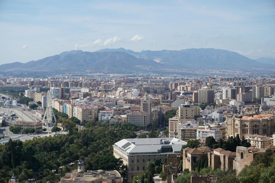 Panoramic view of Malaga cityscape with mountains and architectural details