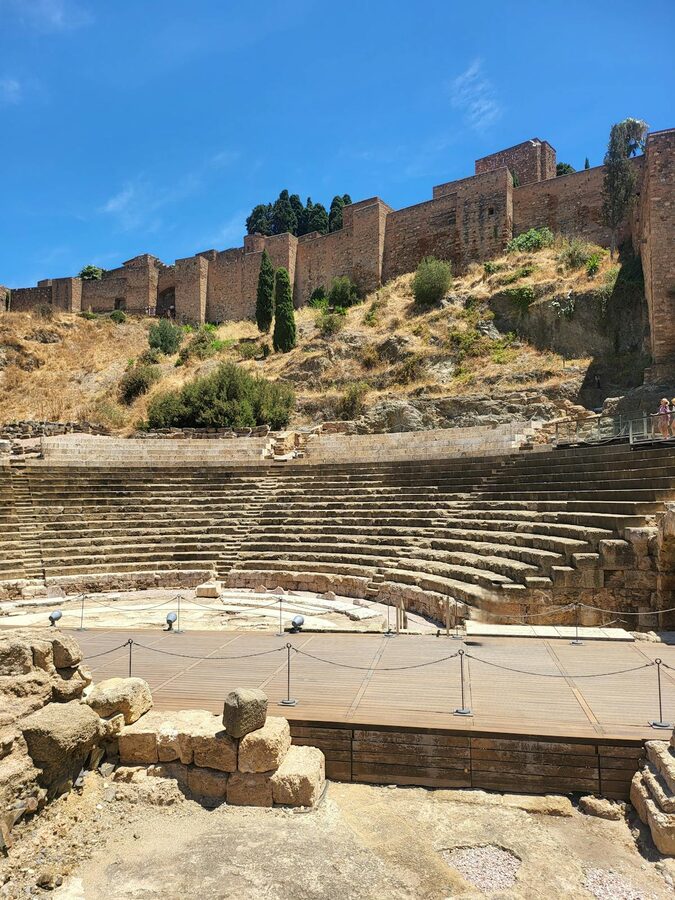 Ancient Roman Theatre ruins in M&aacute;laga with stone seating tiers visible