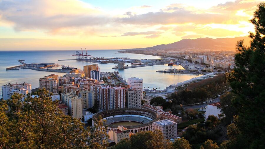 Aerial view of Malaga at sunset showing the port, coastline and La Malagueta bullring