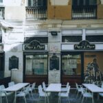 Outdoor seating at a tapas bar in Malaga old town with traditional decor
