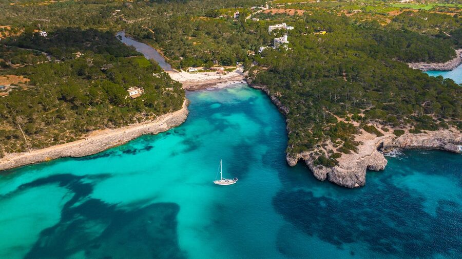 Turquoise waters and dramatic cliffs of Mallorca Balearic coastline from above