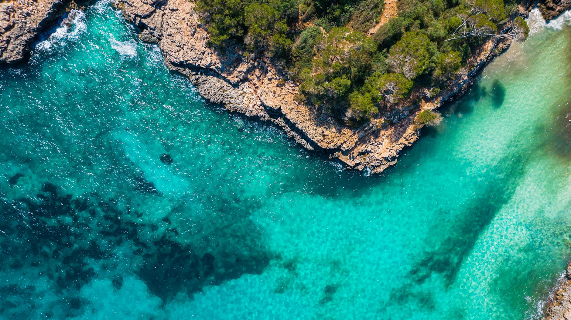 Crystal clear turquoise water in a hidden cove in Mallorca