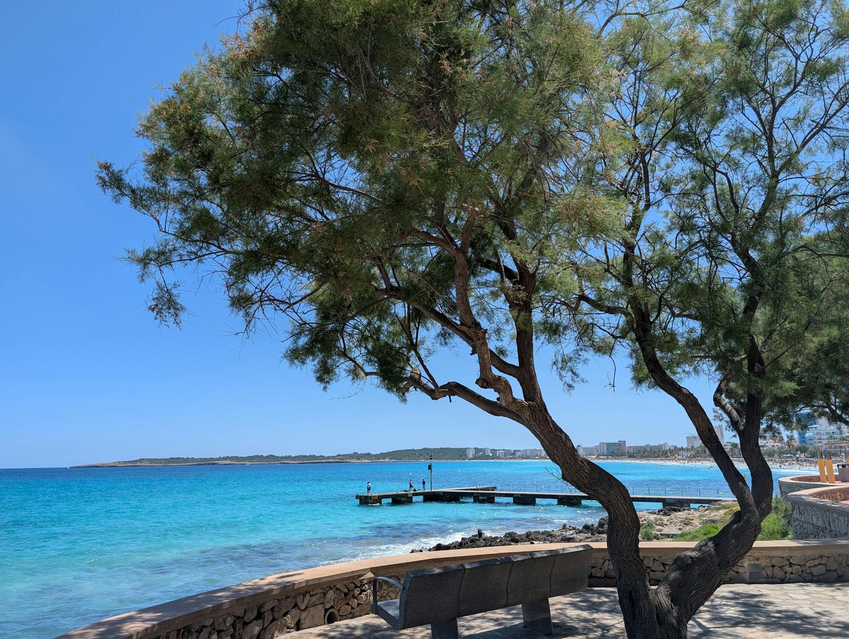 Rocky coastline path along the Mallorca shore with waves crashing against rocks