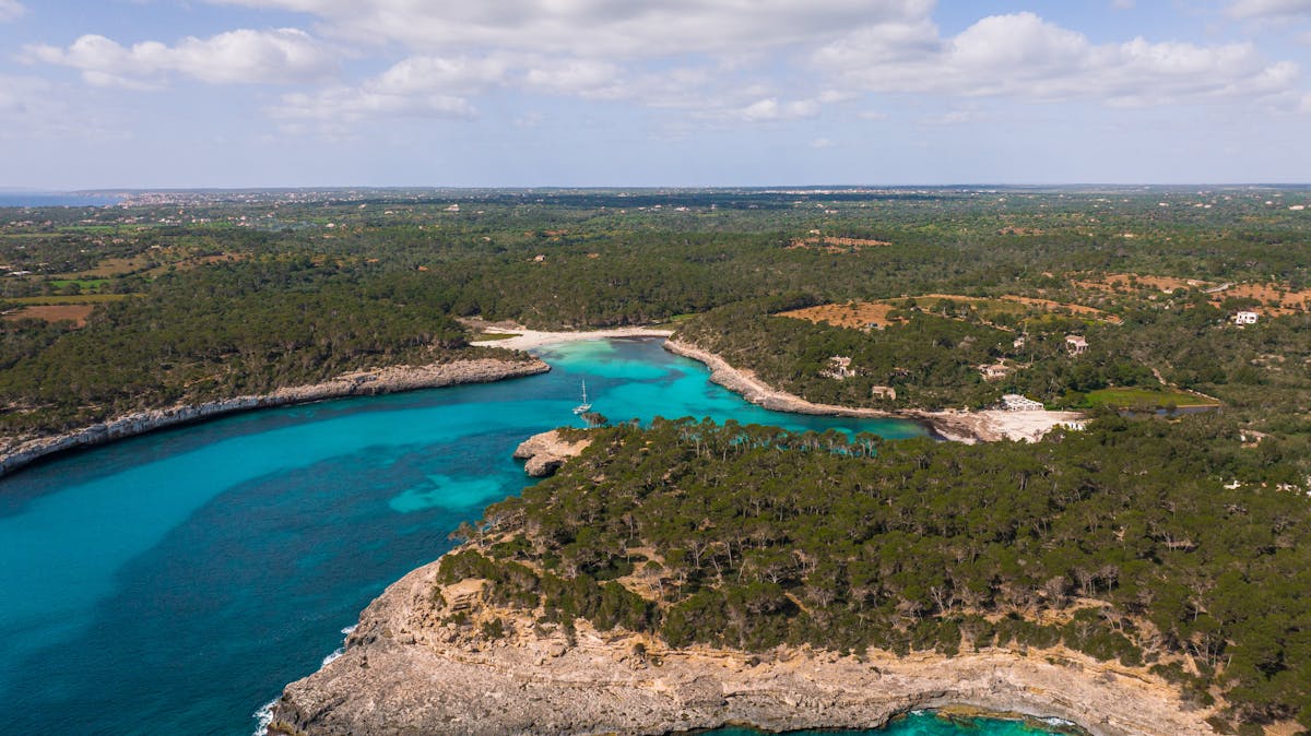 Aerial view of dramatic cliff-lined Mallorca coastline with turquoise waters