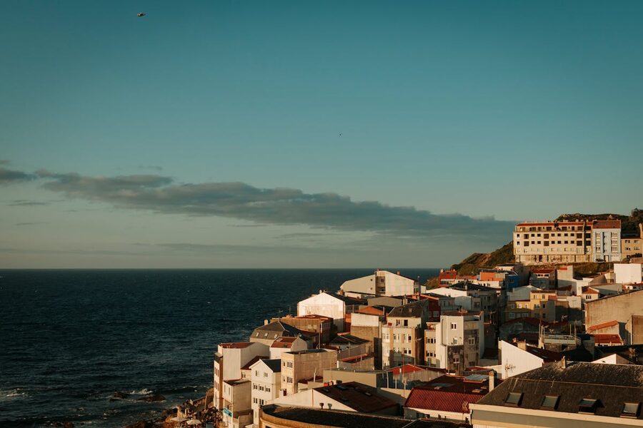 Sunset view of Malpica with colorful rooftops and the Atlantic Ocean in Galicia