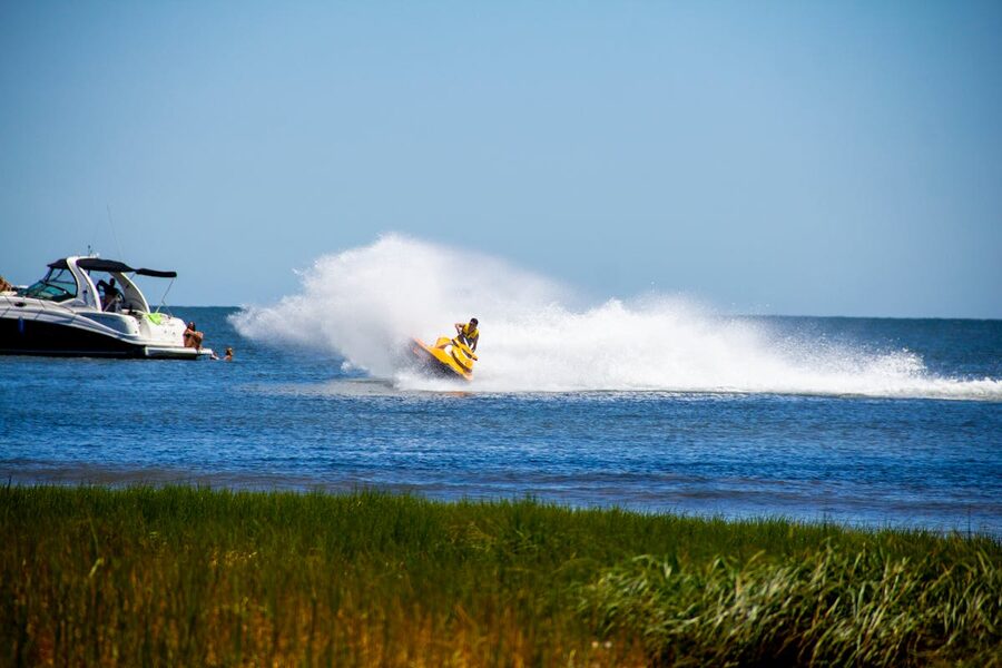 Man riding a jet ski creating spray in the ocean