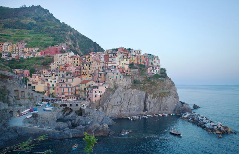 Picturesque view of the colorful buildings of Manarola, Cinque Terre, stacked on a cliff above the blue Mediterranean