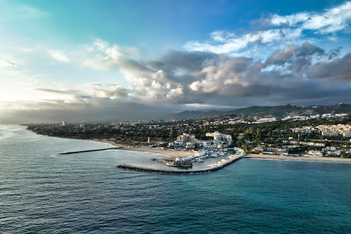 Aerial view of Marbella coastline with mountains and Mediterranean Sea