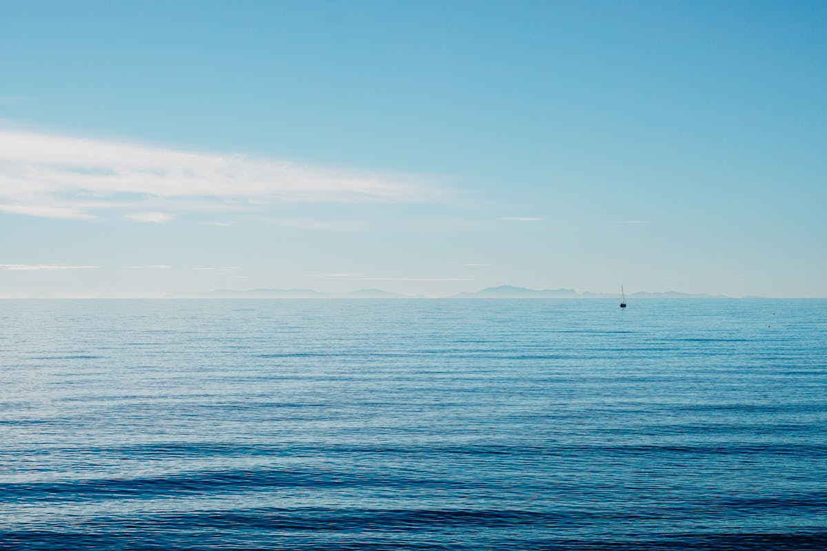 A lone boat on the ocean horizon near Marbella Spain