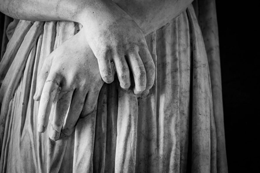 Classical marble bust sculpture showing refined details and texture in a gallery setting