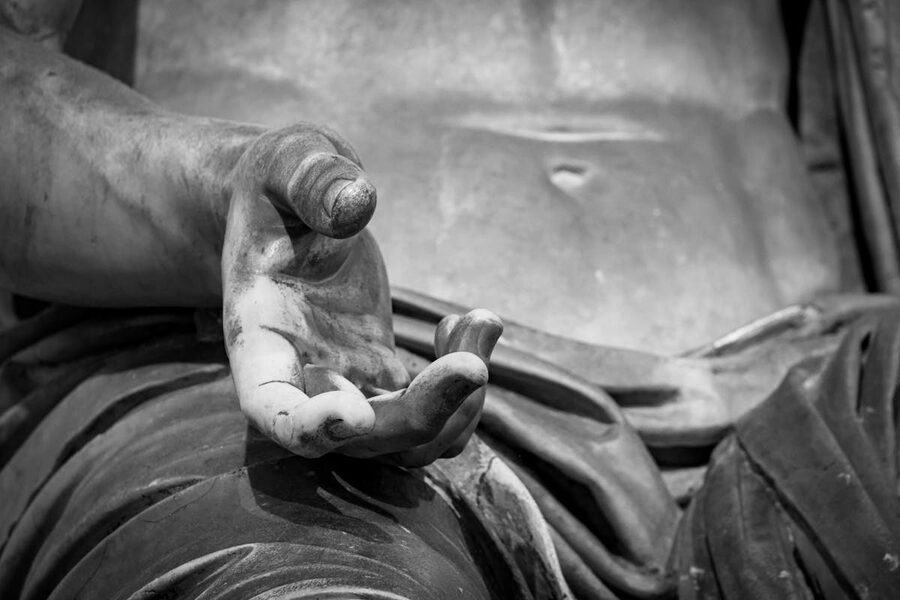 Close-up detail of a classical marble sculpture showing fine carving and texture