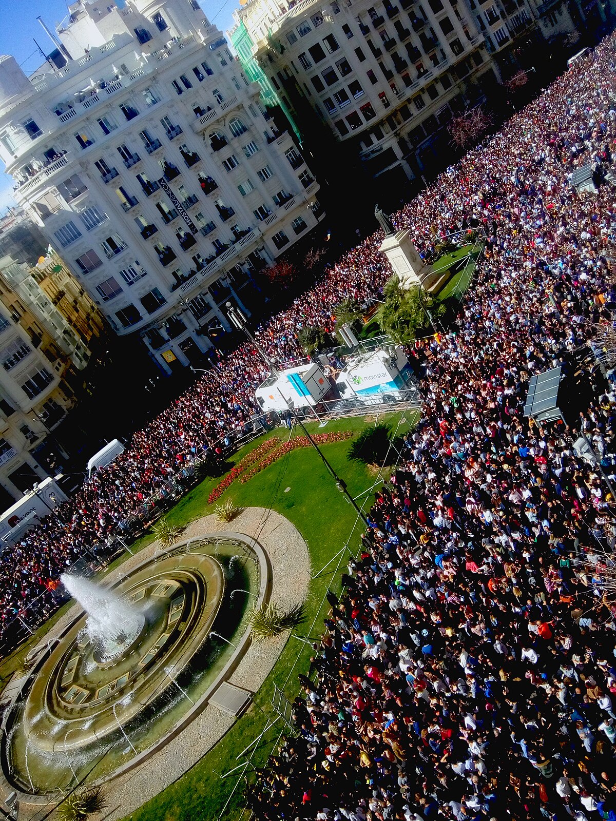 Dense crowd gathered in Plaza del Ayuntamiento waiting for the daily mascleta pyrotechnic display