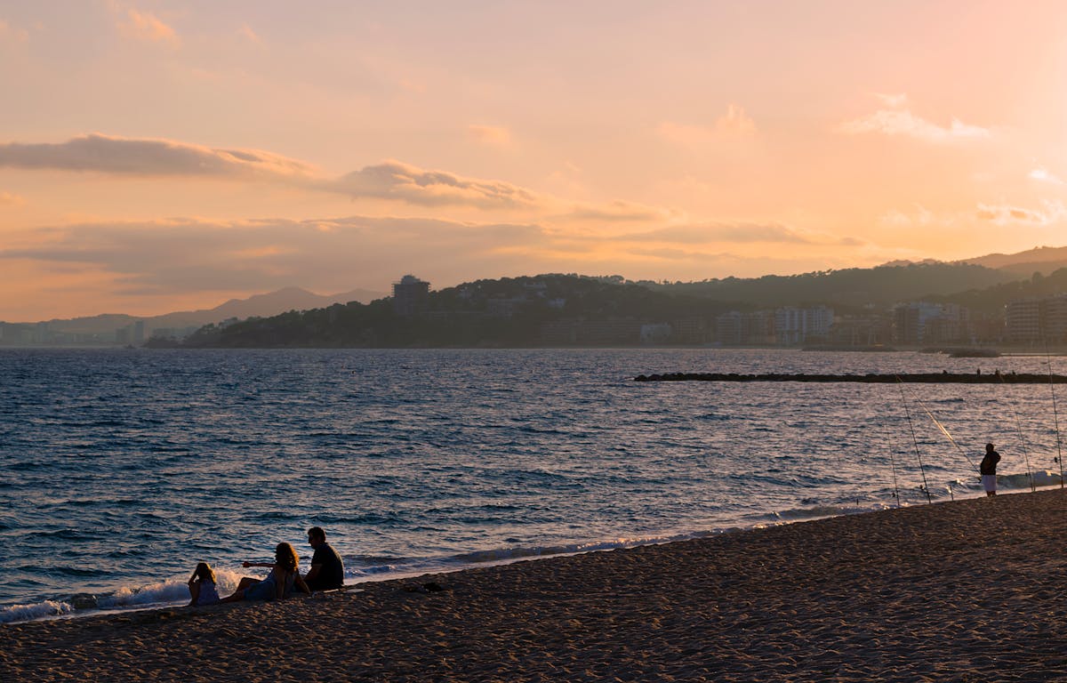 Relaxing summer evening at a Mediterranean beach with a stunning sunset