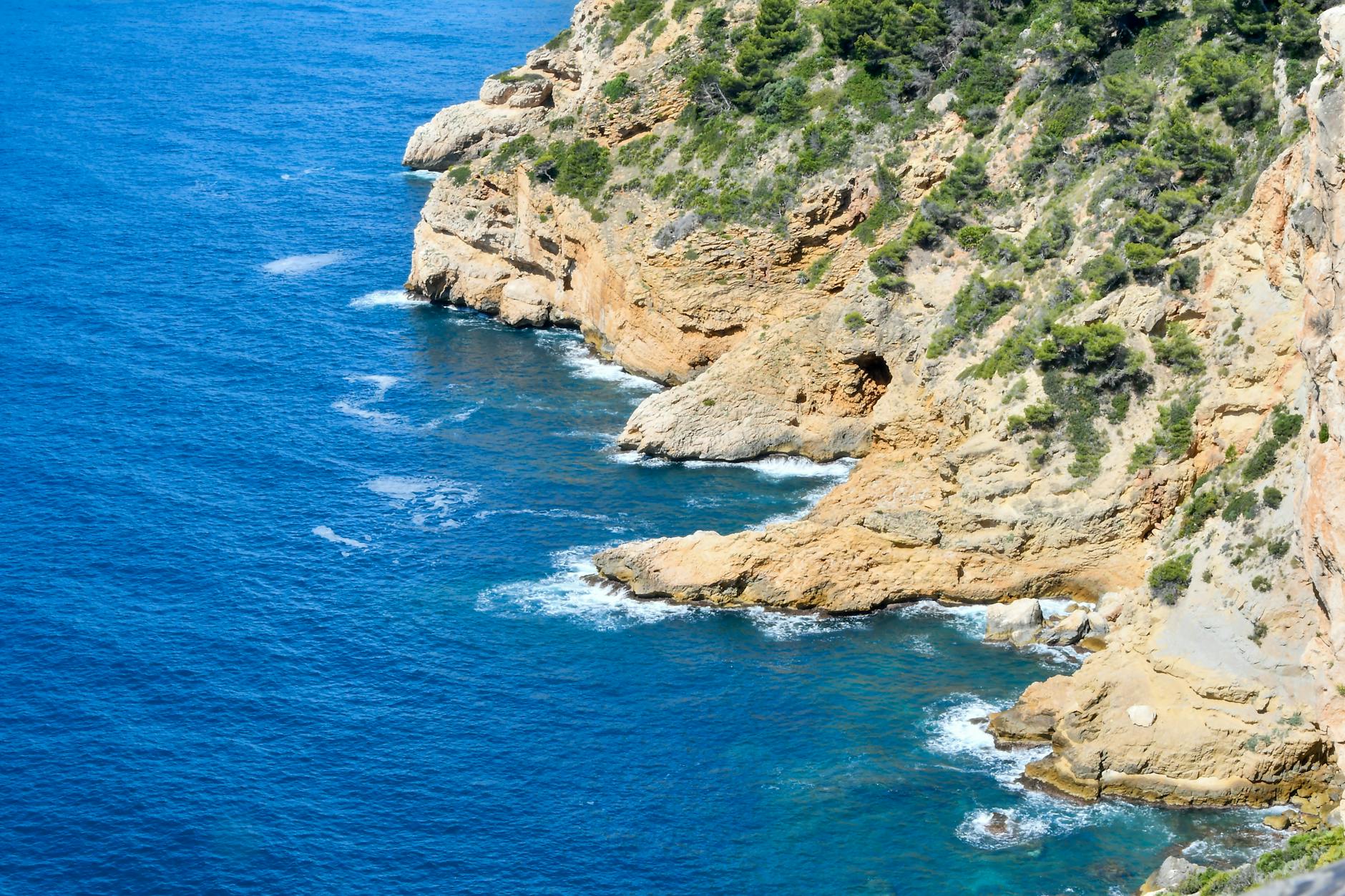 The Mediterranean coastline of Catalonia with rocky shores and clear blue water