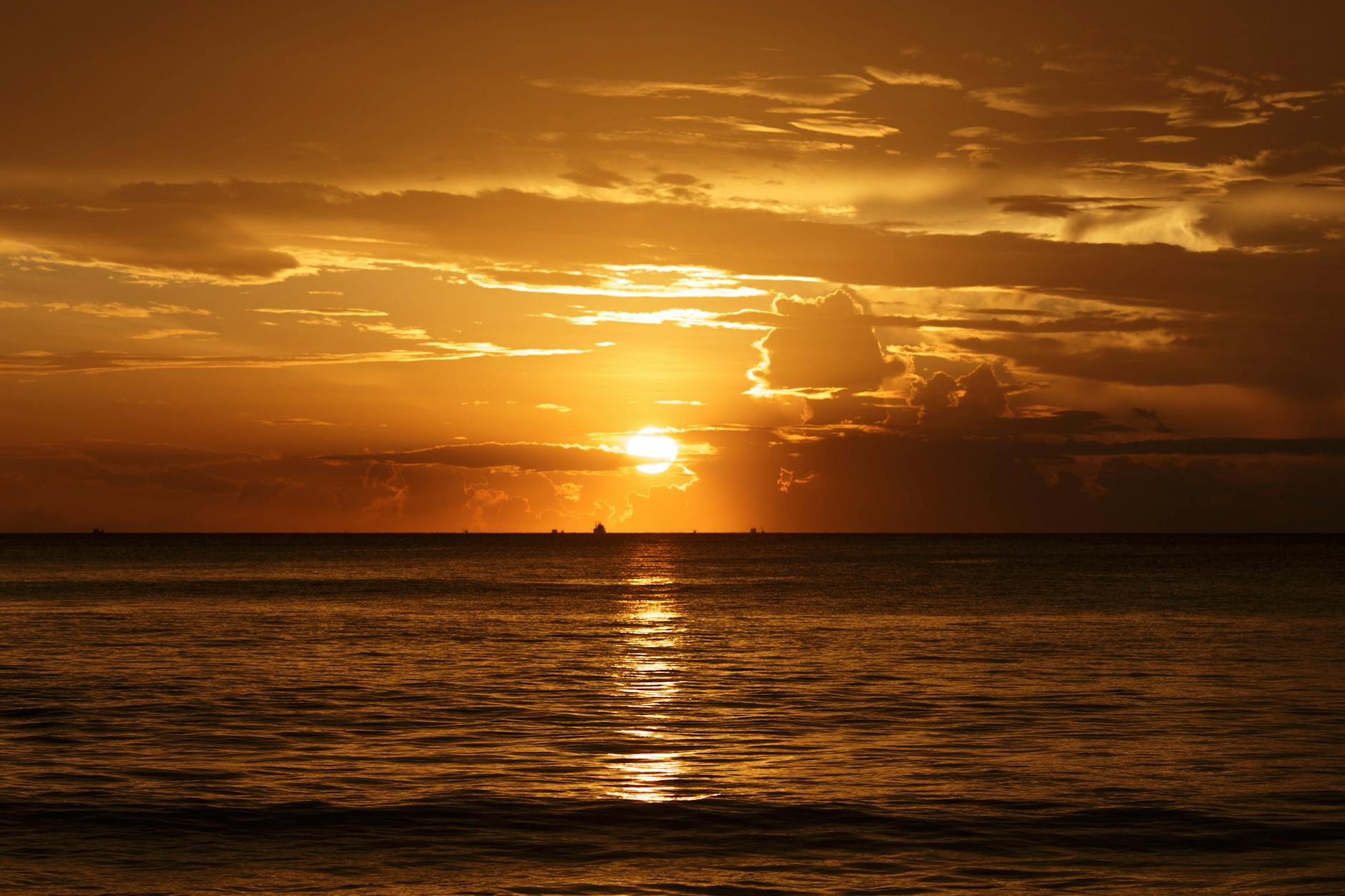 Golden sunset light reflecting off calm Mediterranean waves