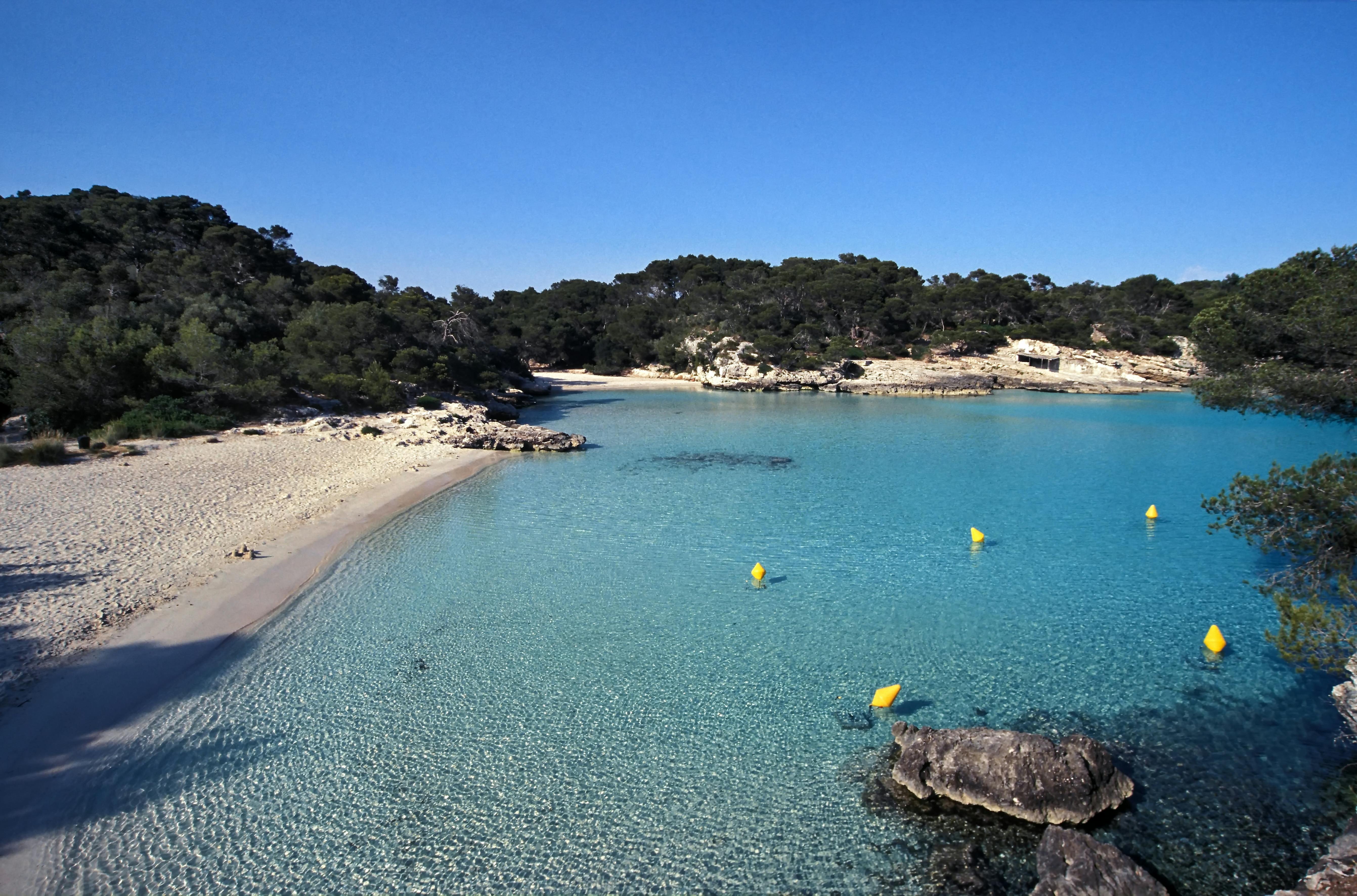 Sandy beach cove with turquoise waters in Menorca Balearic Islands