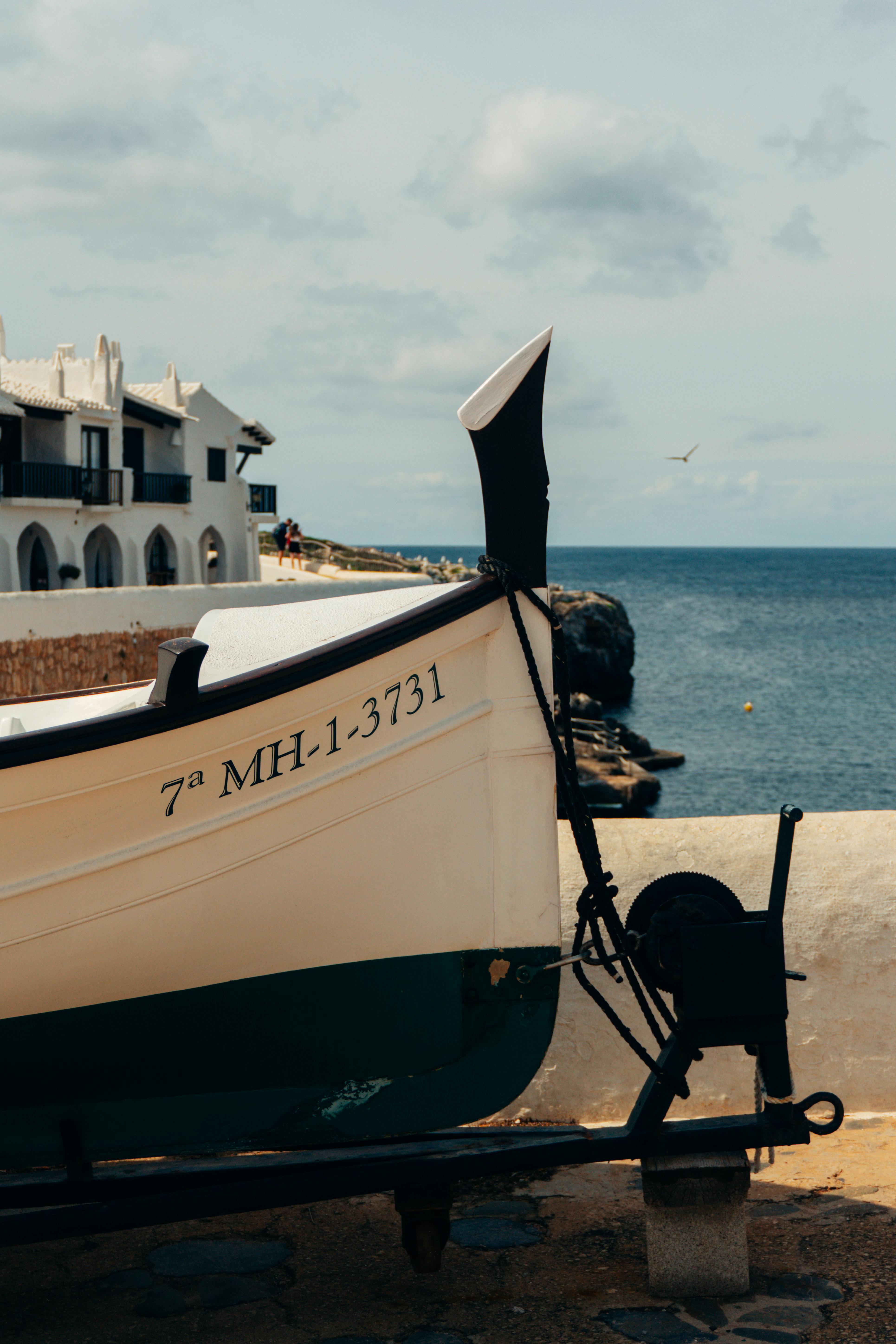 Coastal scene in Ciutadella de Menorca featuring a boat on clear water