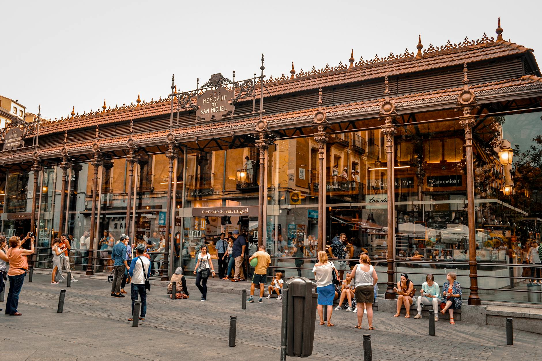 Interior of Mercado de San Miguel in Madrid showing lively activity and iron architecture