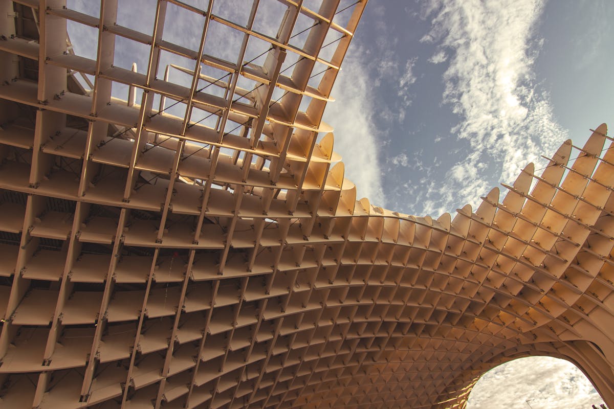 Looking up at the modern wooden lattice structure of Metropol Parasol in Seville