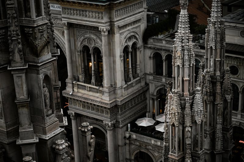 Gothic spires and marble sculptures on the rooftop terraces of Milan Cathedral