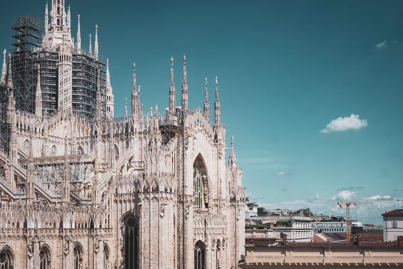 Duomo di Milano cathedral with Gothic spires against blue sky