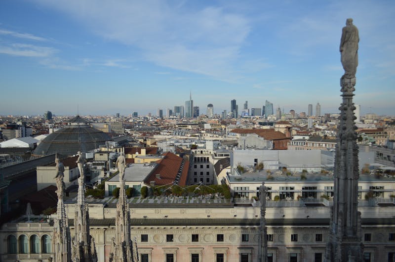 Aerial view of Milan skyline from atop the Duomo with clear blue sky