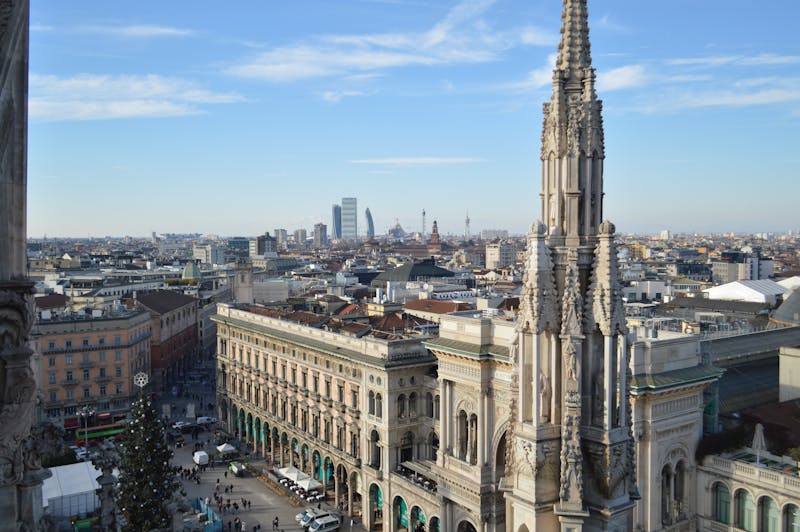 Aerial view of the Milan city skyline with the Duomo spire in the foreground