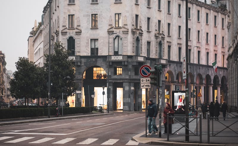 Historic street architecture in Milan Italy with pedestrians