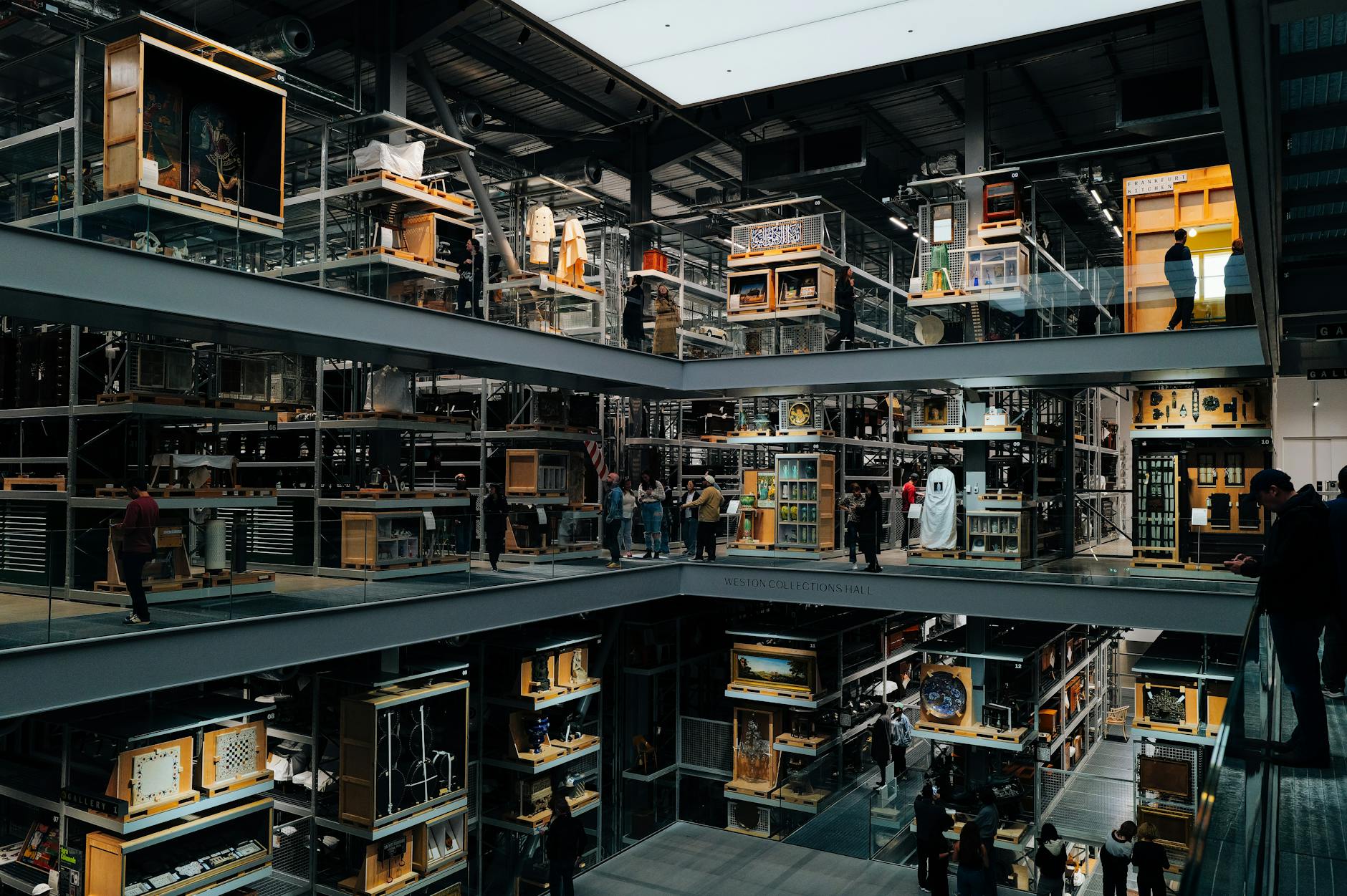 Multi-level modern art museum interior with visitors browsing exhibitions