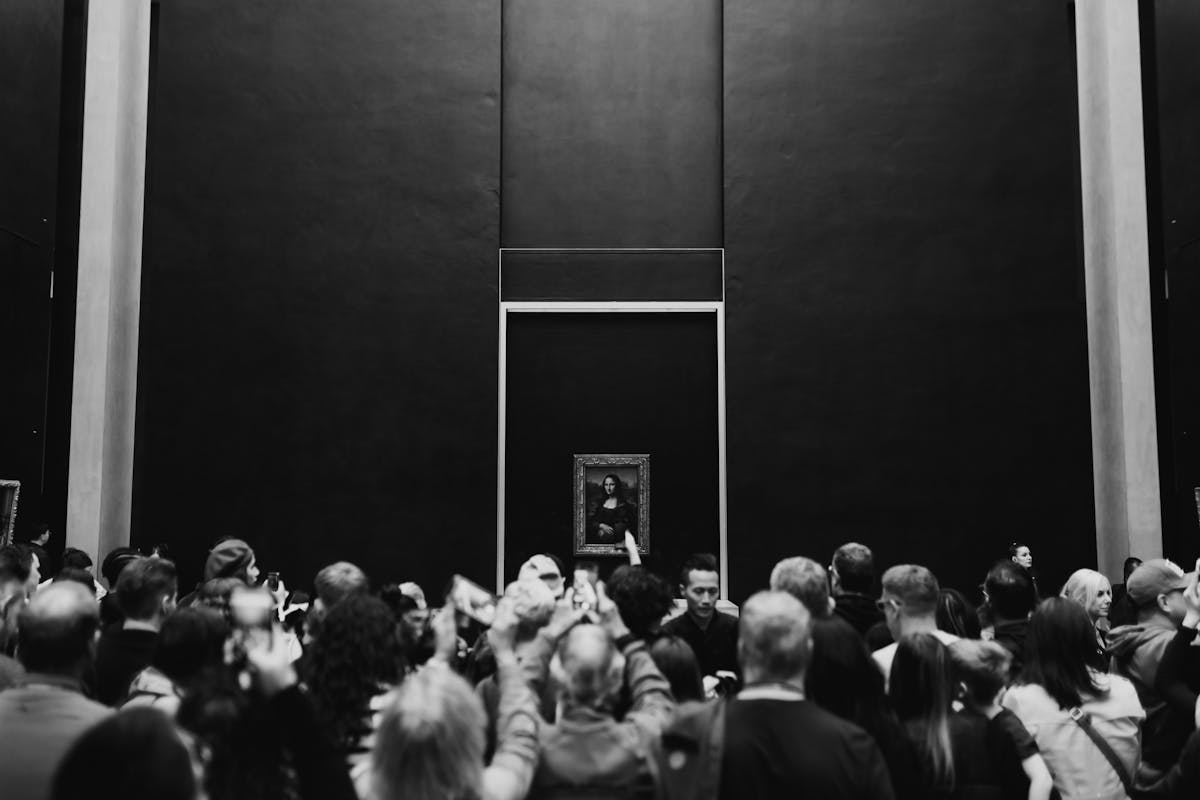 A large crowd gathers to view the Mona Lisa at the Louvre Museum