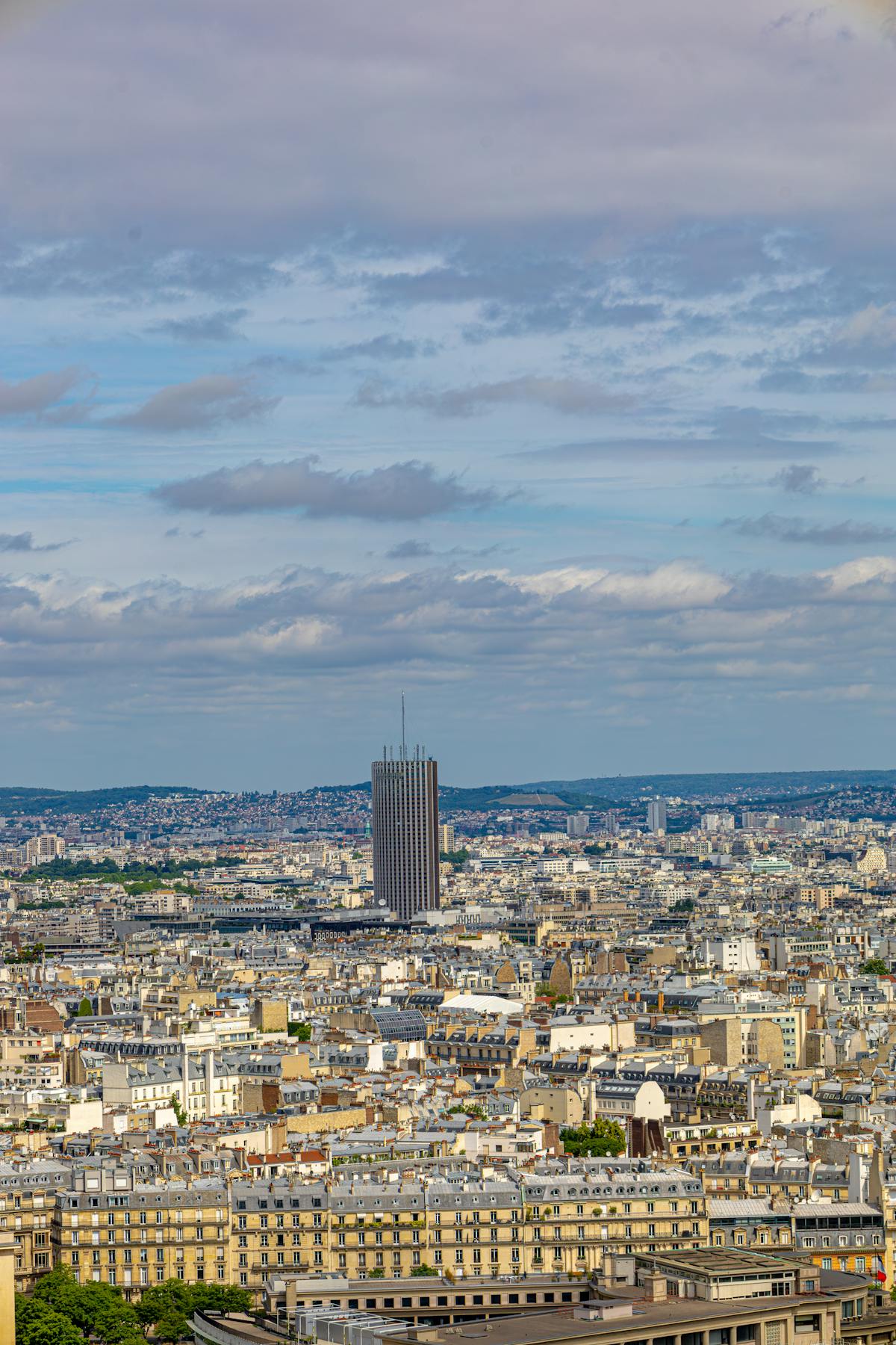Montparnasse Tower standing tall above Paris buildings with vibrant sky