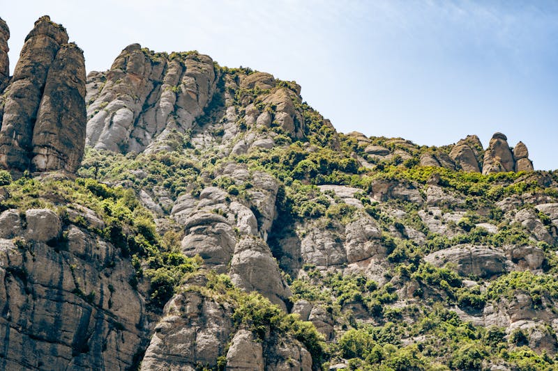 Tall distinctive rock pillars of Montserrat against bright blue sky