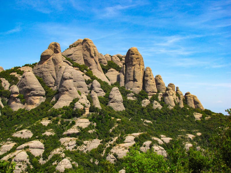 Jagged saw-tooth rock formations of Montserrat mountain against blue sky